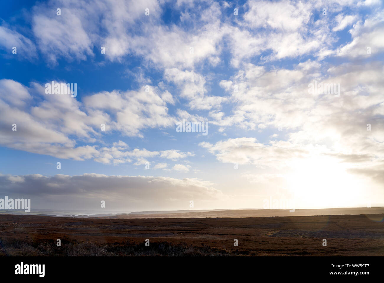 Blue sky and sun rising over Blanchland Common moors in the North of ...