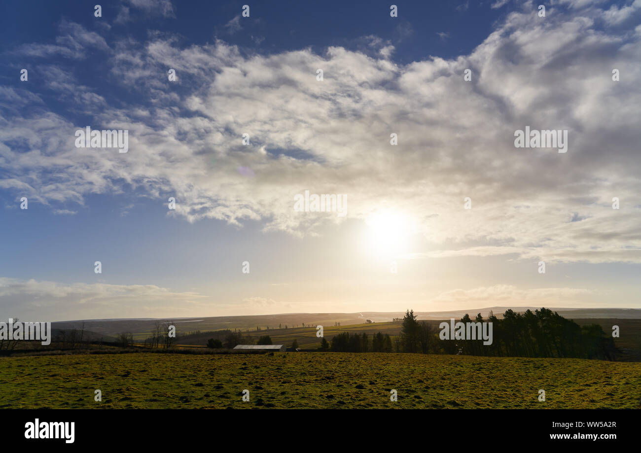 Blue sky and sun rising over Blanchland Common moors in the North of ...