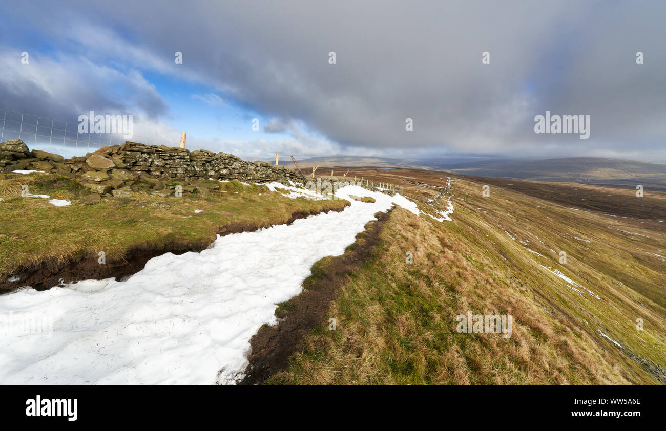 A snow filled path leading up to the summit of Whernside, one of the ...
