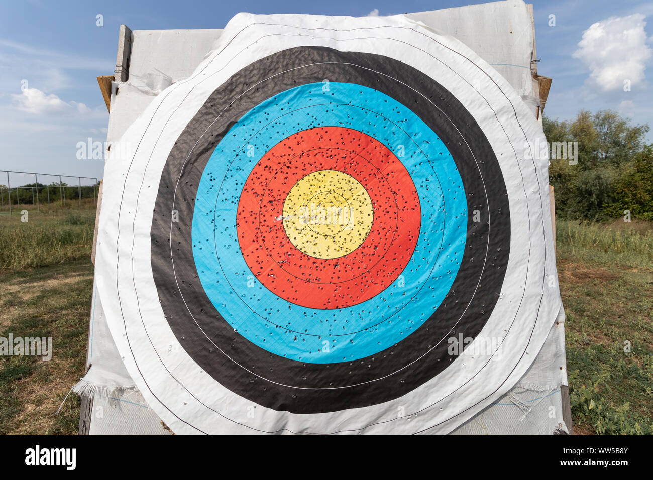 Archery target covered with arrow holes Stock Photo - Alamy