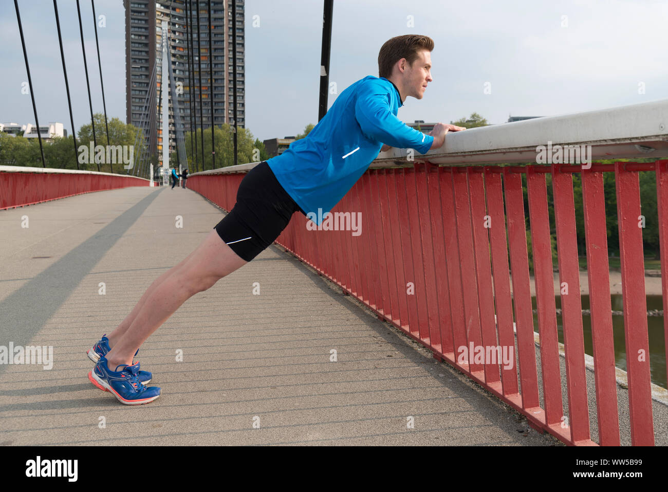 Man stretching with hands at balustrade hi-res stock photography and ...
