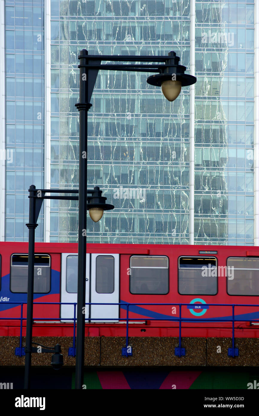 A subway train driving on a bridge along a high rise Stock Photo - Alamy