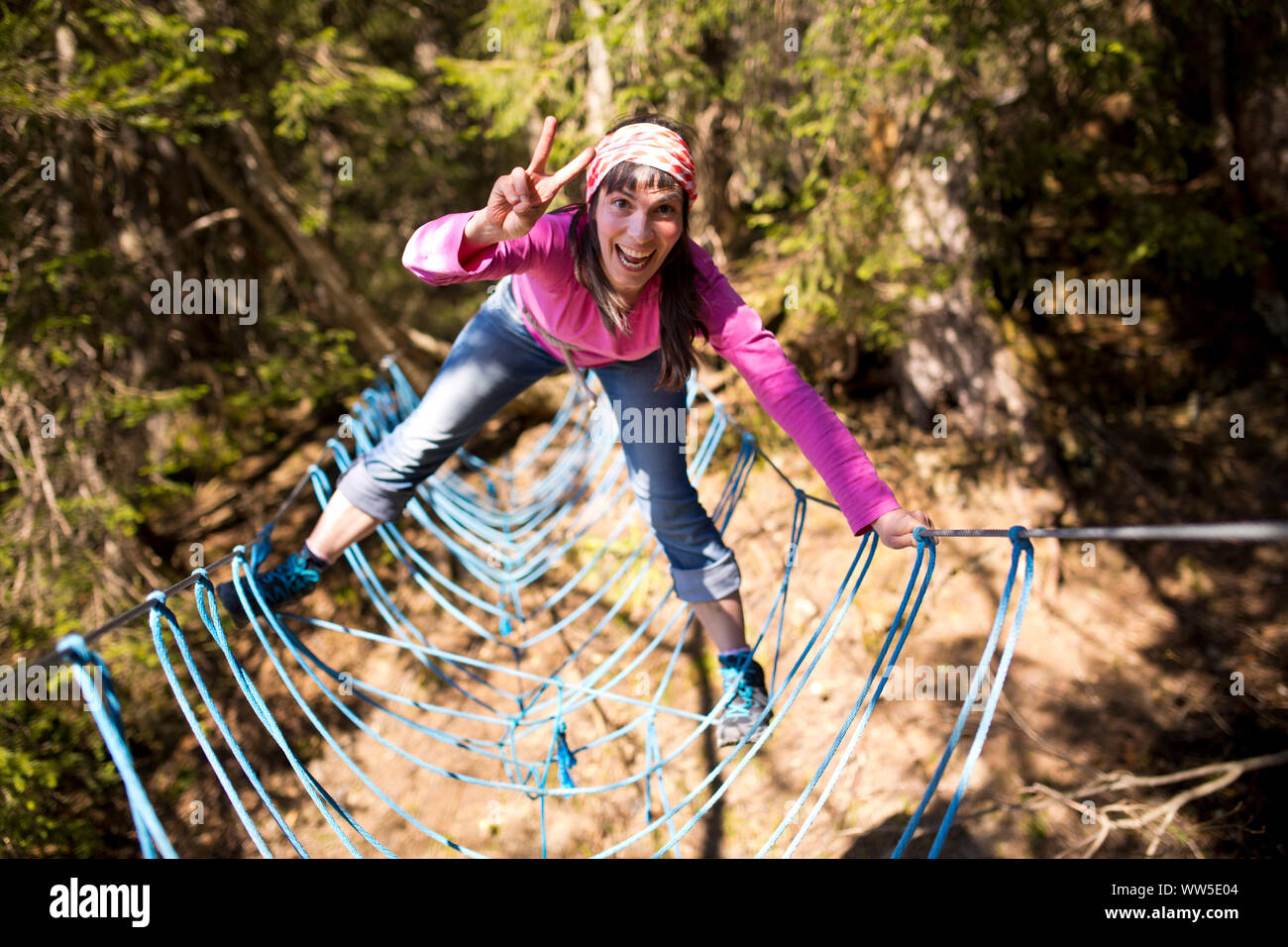 30 40 years old woman balancing on rope bridge hi-res stock photography ...