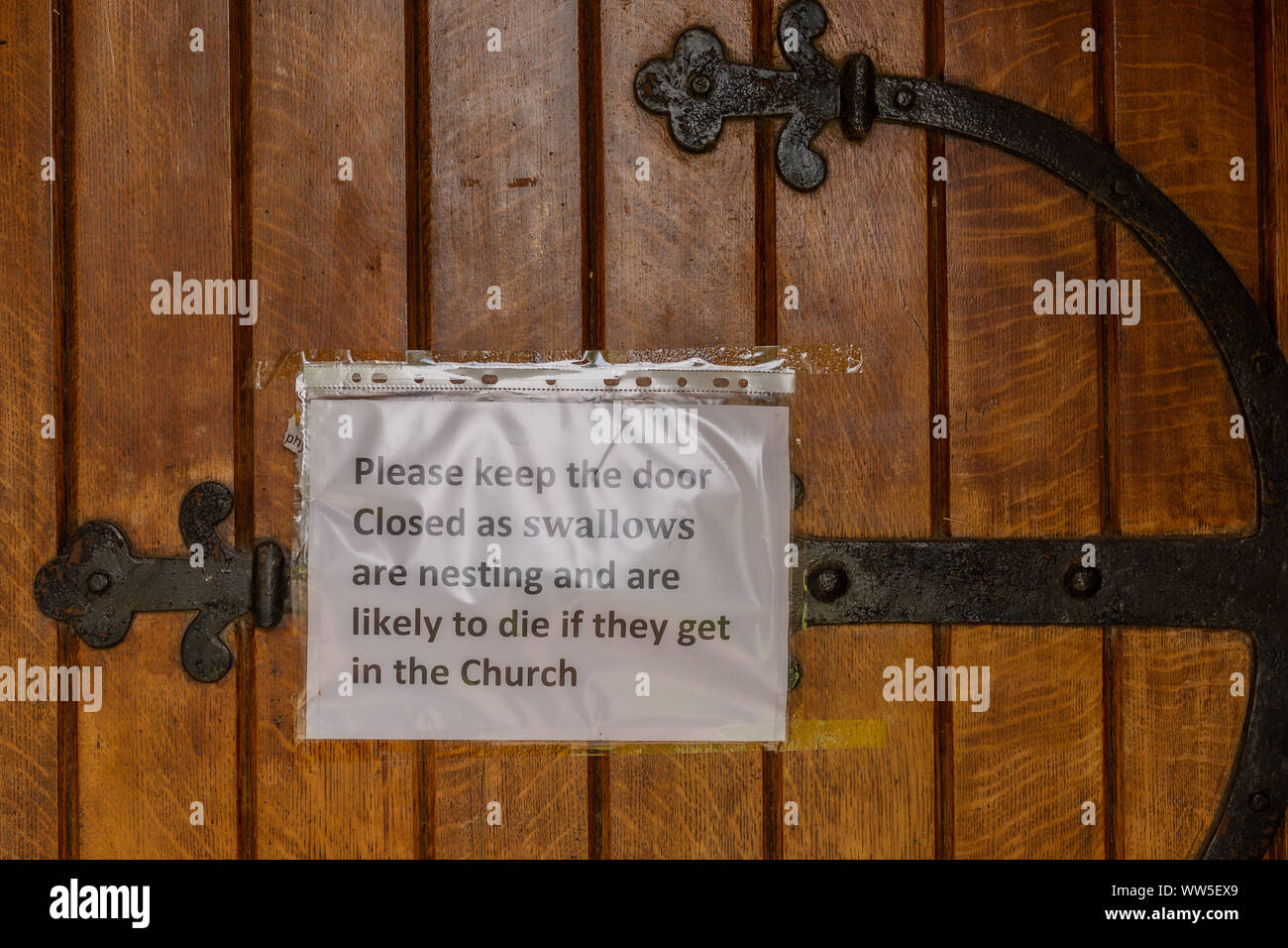Unusual sign warning to keep church door closed Stock Photo - Alamy