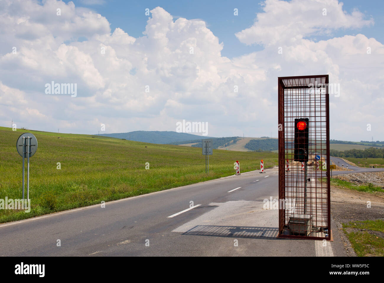 Red traffic light in cage at an empty street hi-res stock photography ...