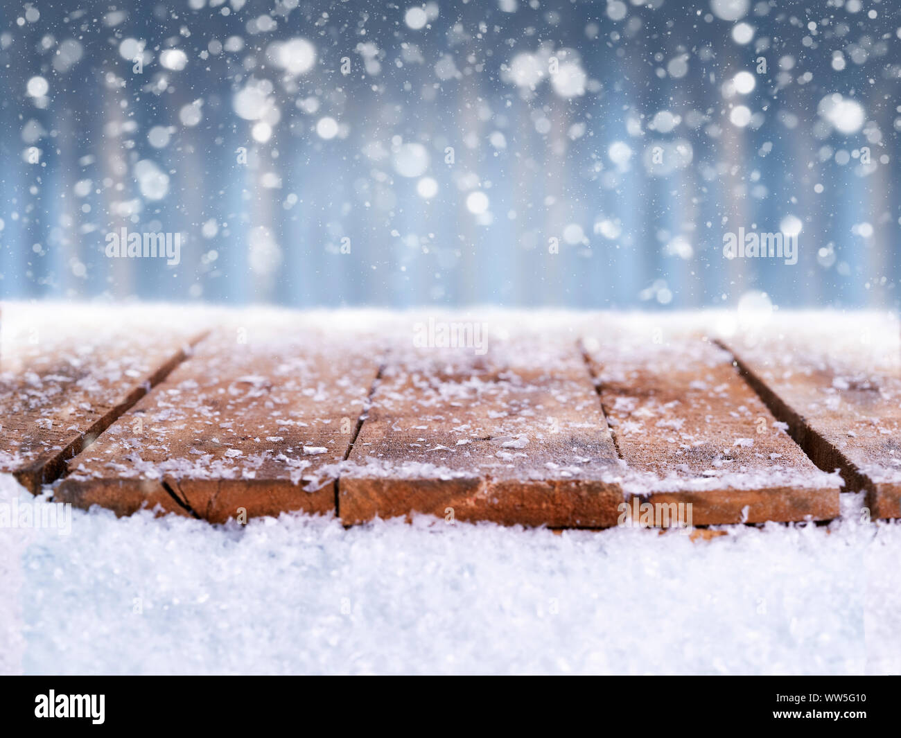 Wooden table, bench covered in snow with a Christmass, wintery and ...