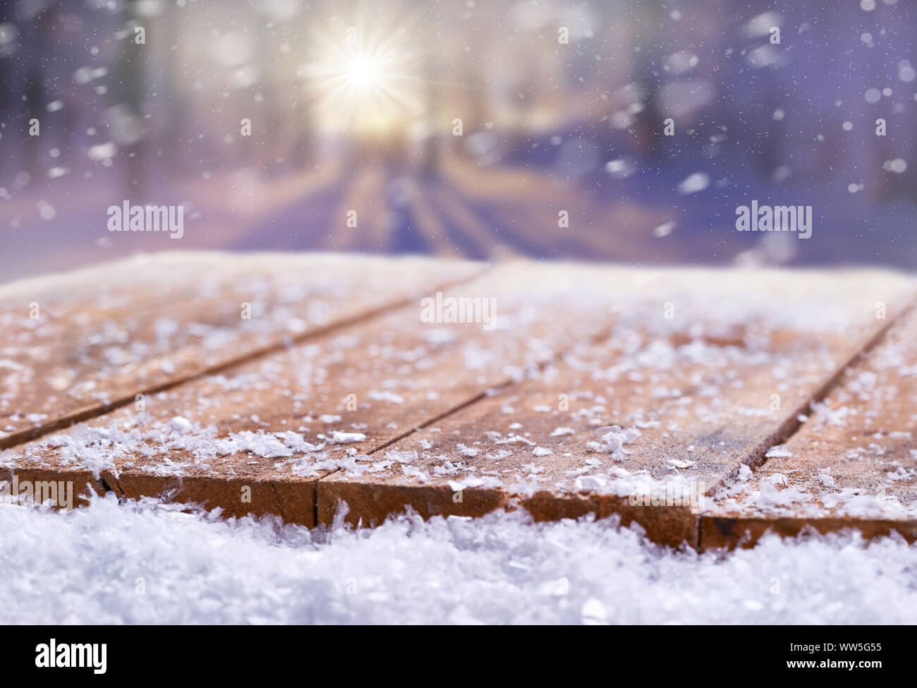 Wooden table top covered in snow with a Christmass, winter and snowy ...