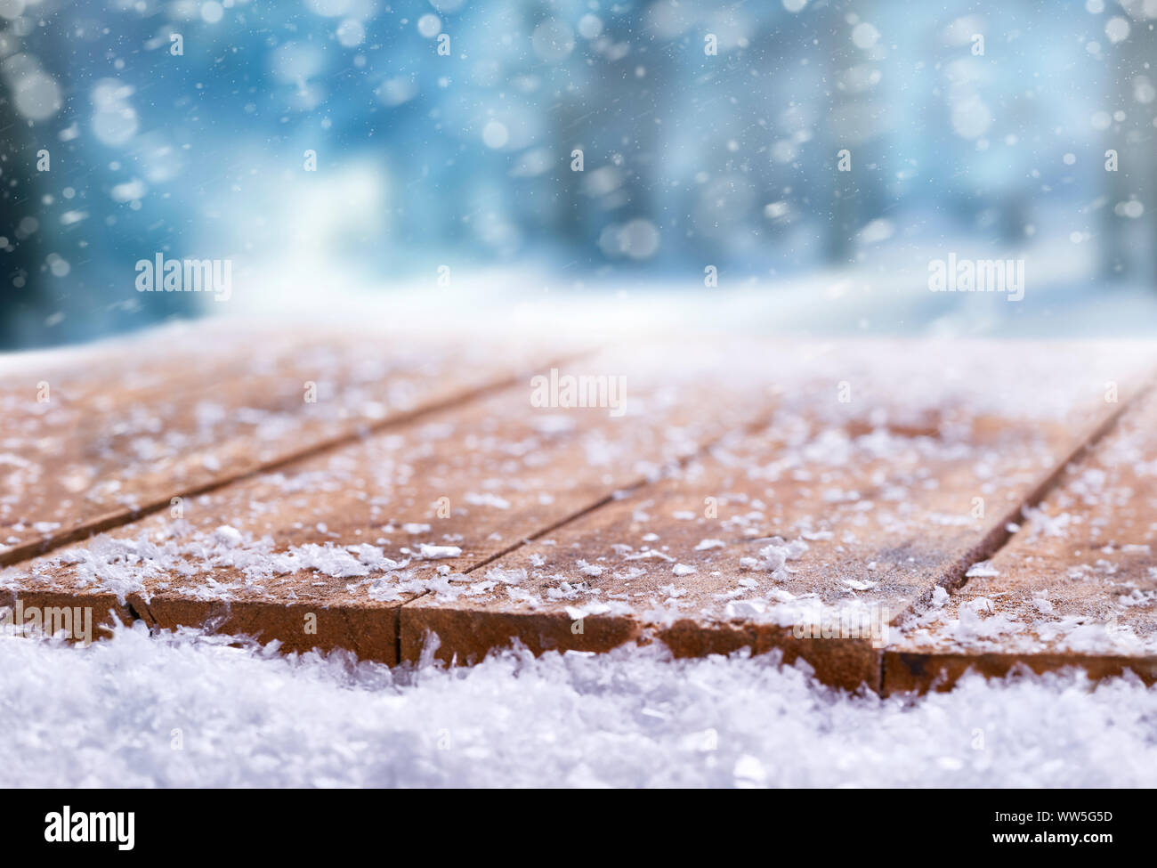Wooden table top covered in snow with a Christmass, winter and snowy ...