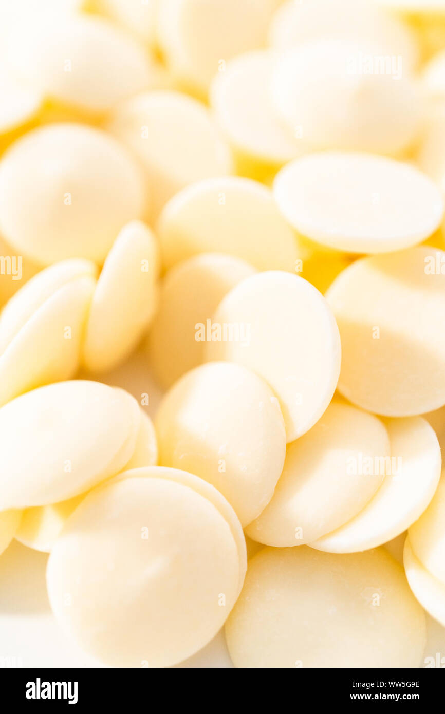 White round chocolate chips for melting chocolate shapes on a white ...