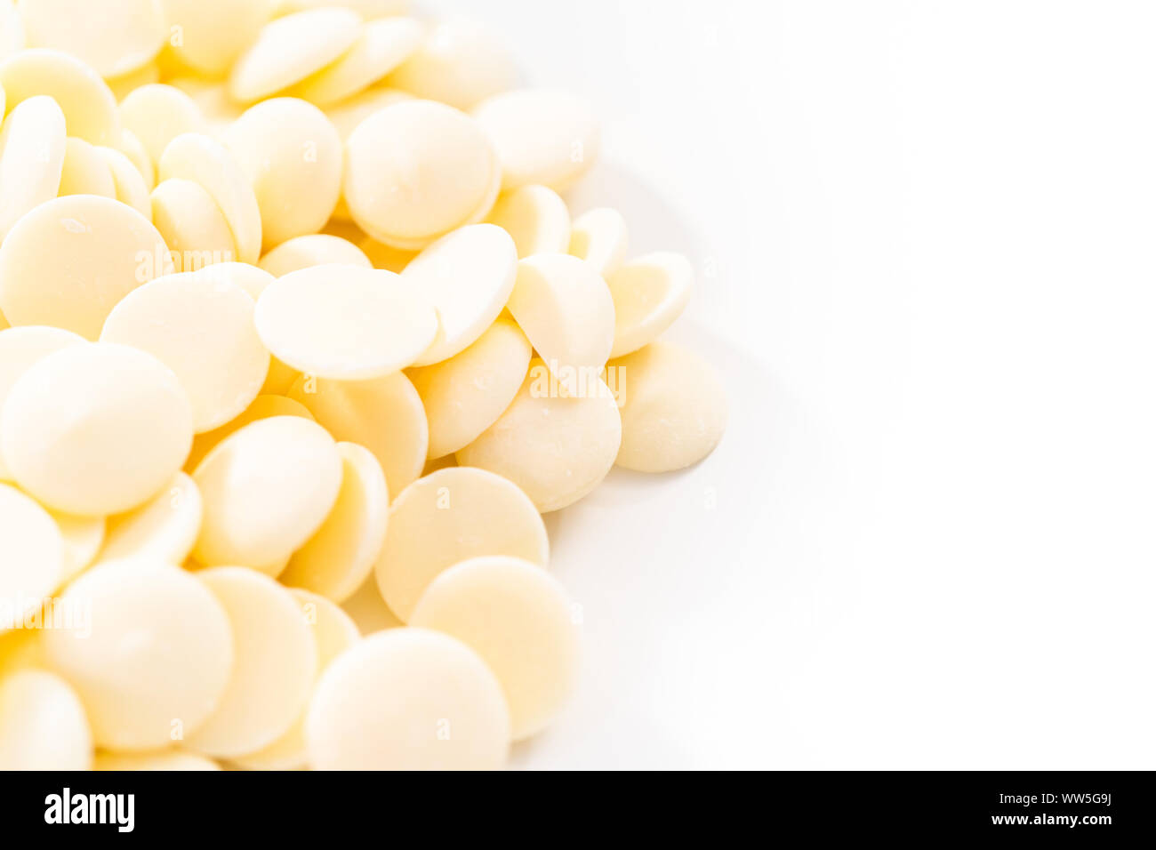 White round chocolate chips for melting chocolate shapes on a white ...