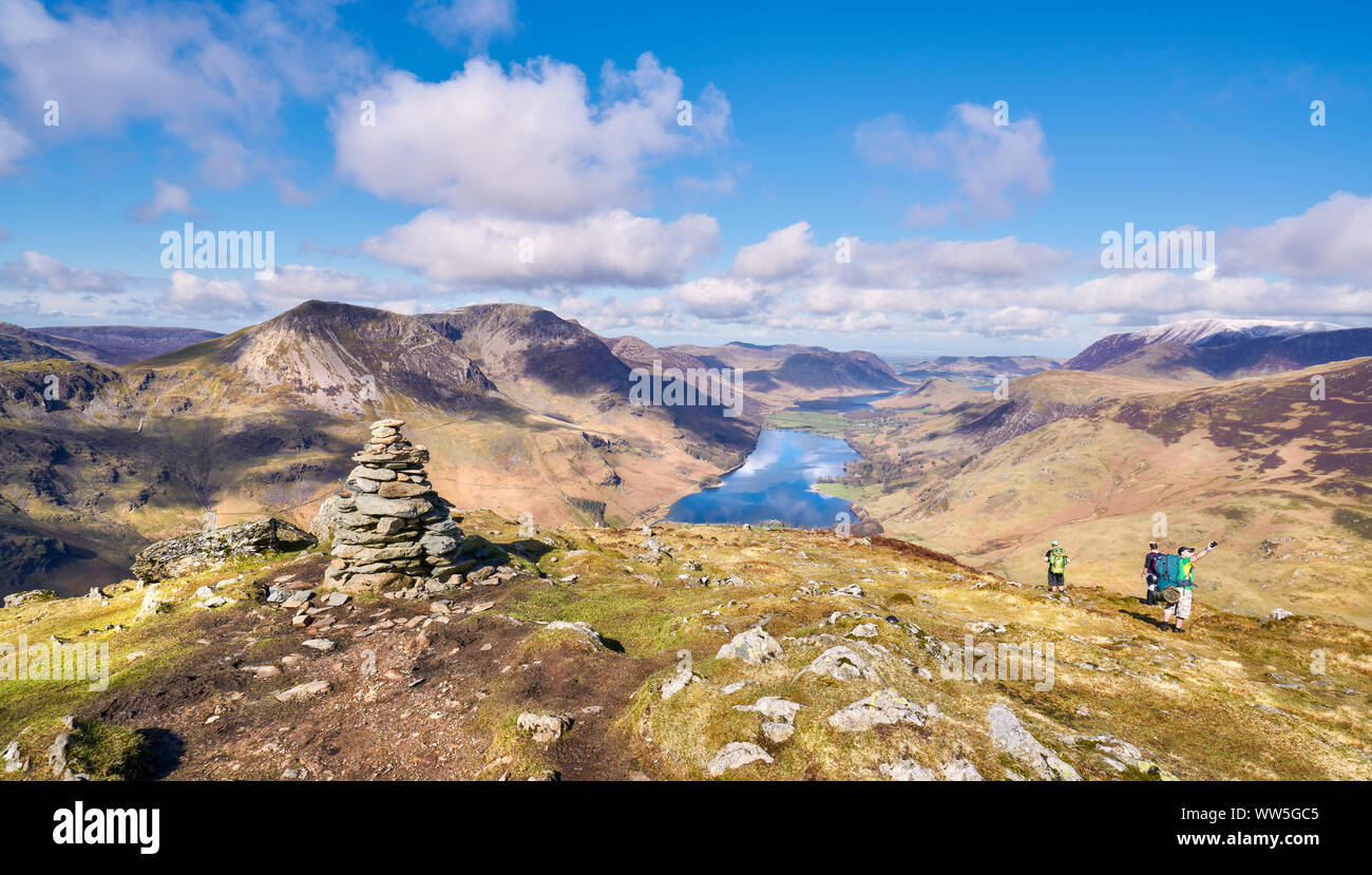 Three hikers descending the summit of Fleetwith Pike, English Lake ...