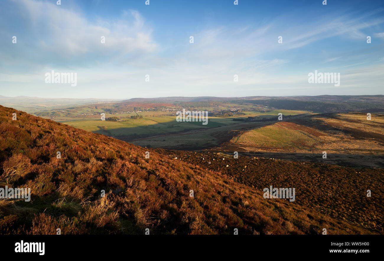 Red, Orange and yellow glow of a sunset over moors and hills in the ...