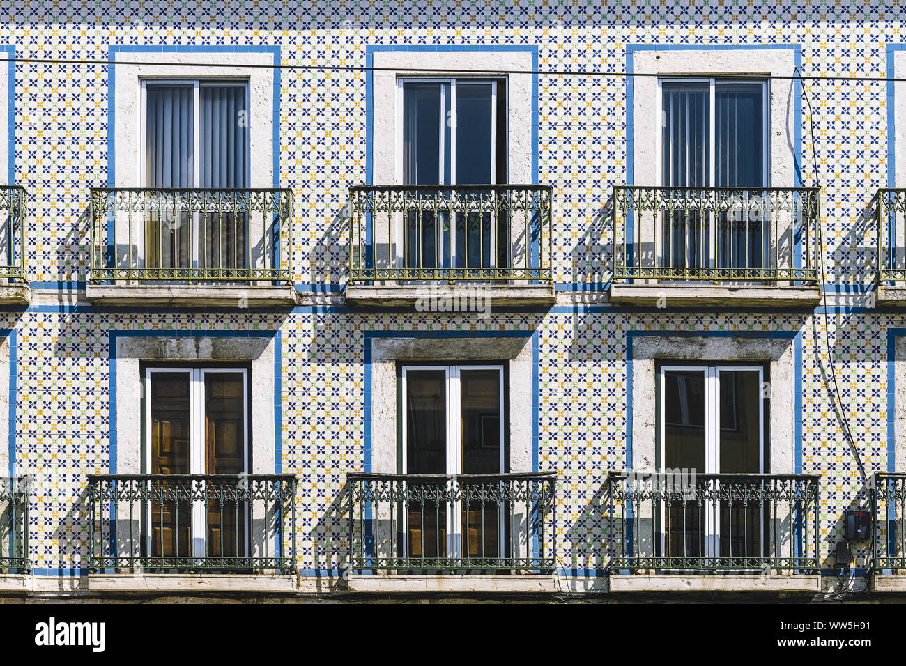 typical vintage tile facade of a portuguese building with windows ...