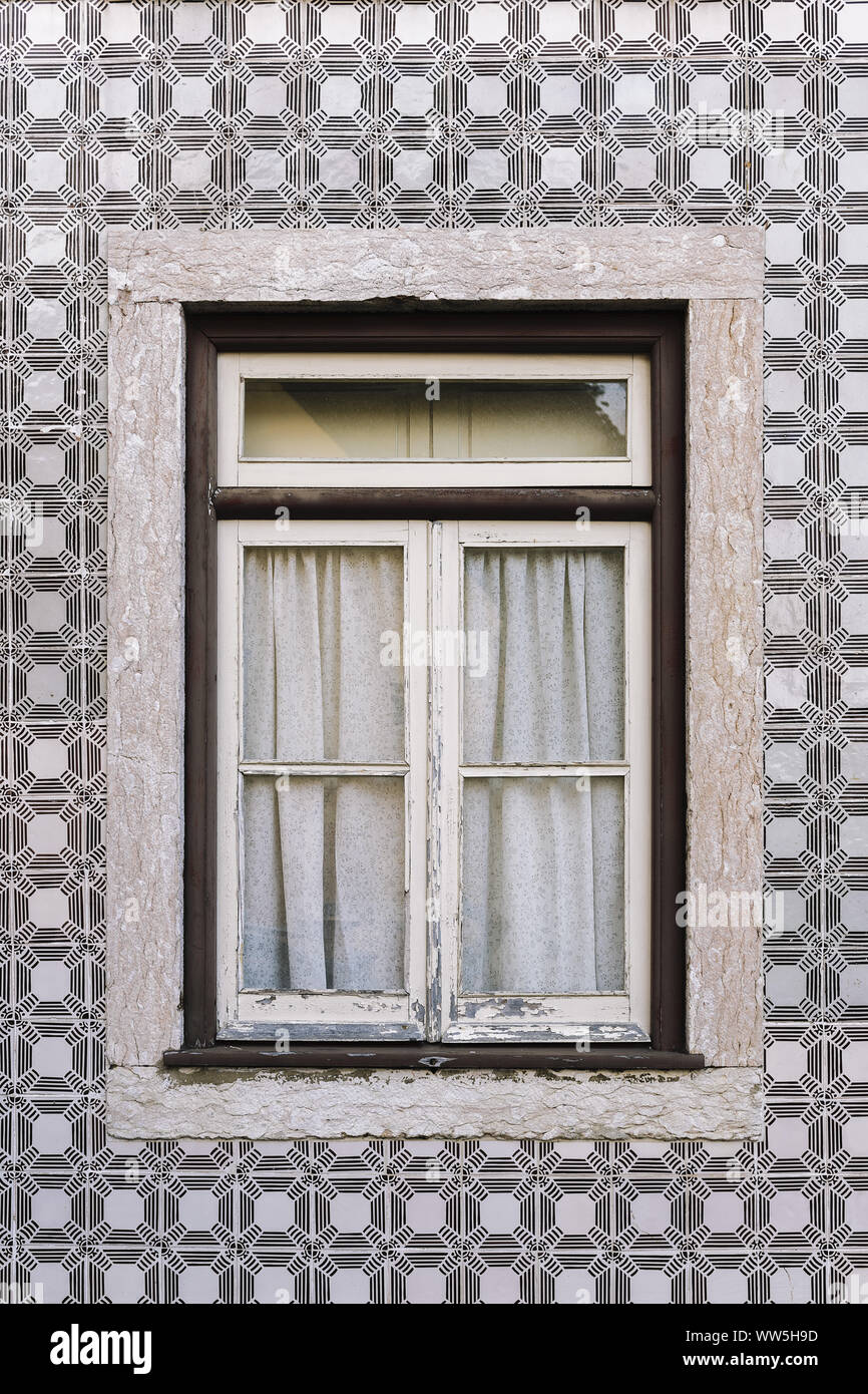 vertical photo of a typical house with vintage wooden window in an old ...