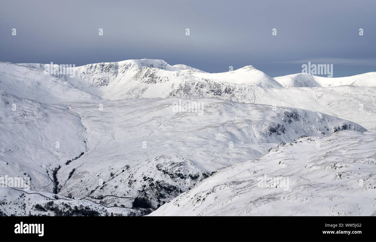 The snow covered summits of Helvellyn, Striding Edge and Catstye Cam ...