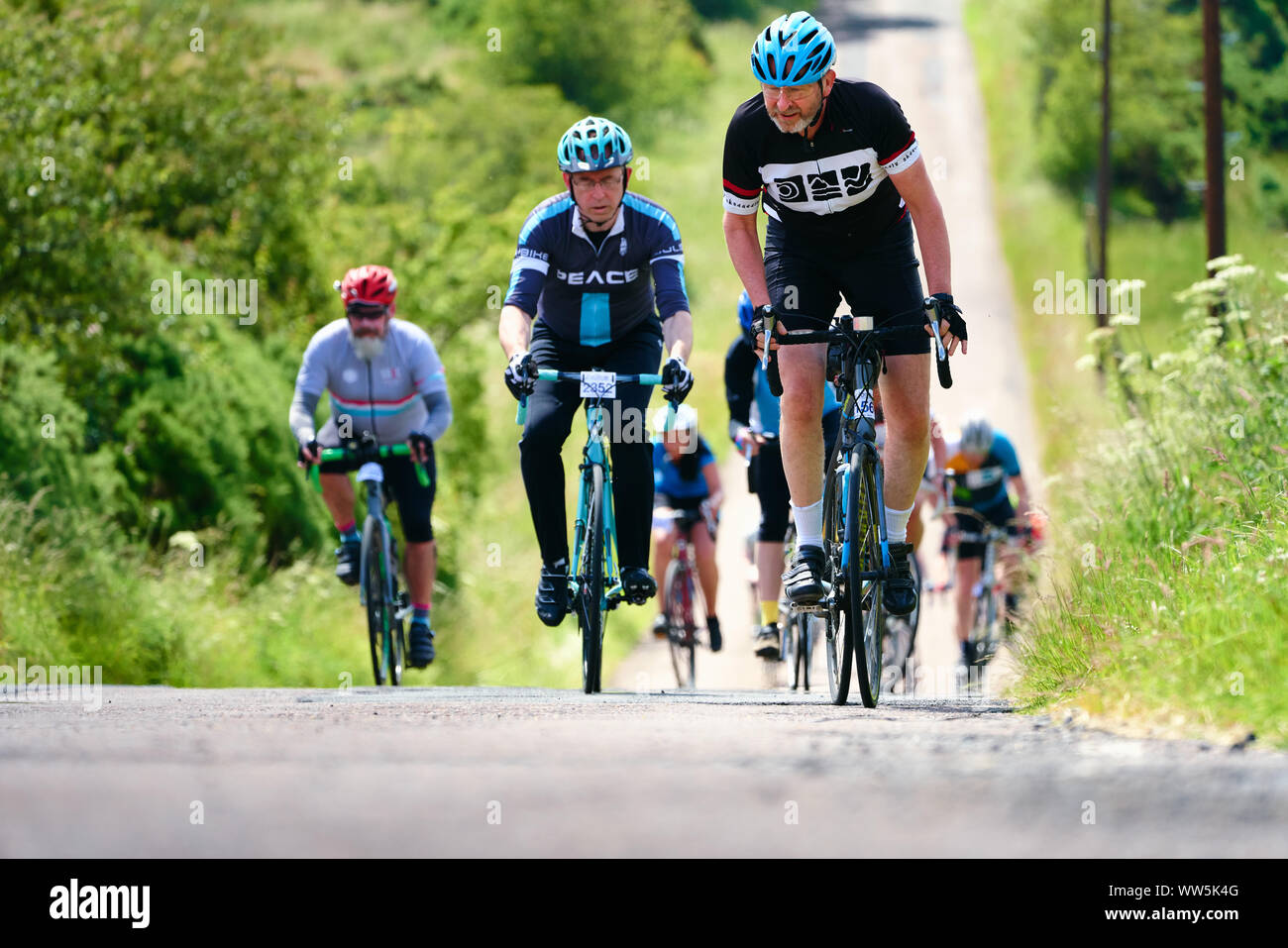 Male cyclists riding uphill hi-res stock photography and images - Alamy