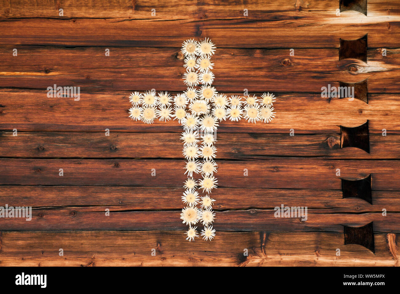 Flower cross at wooden wall of an alpine hut Stock Photo - Alamy