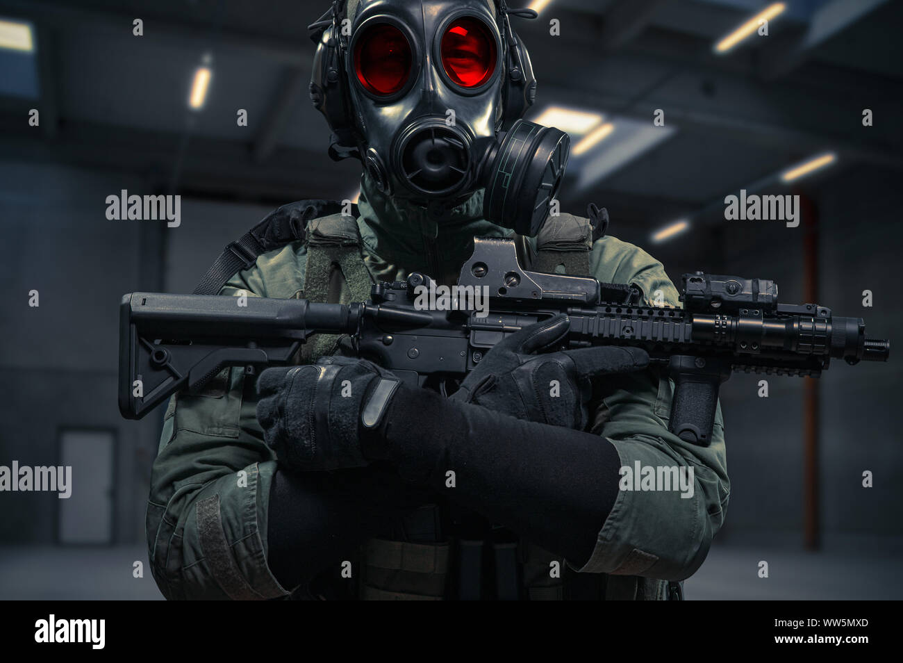 Brave military man in gasmask is holding his machine gun Stock Photo ...