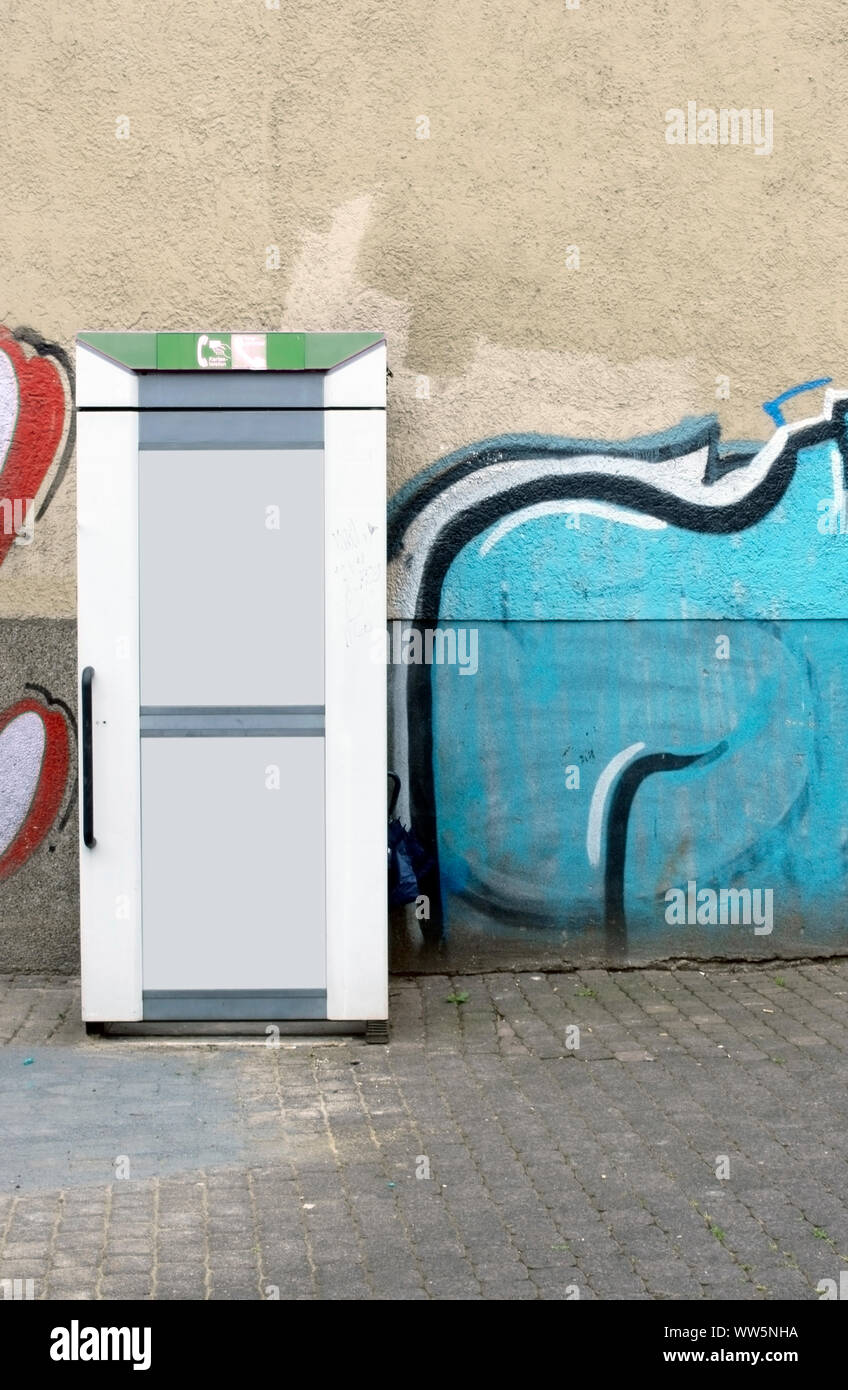 Photography of a telephone box on a wall with graffiti Stock Photo - Alamy