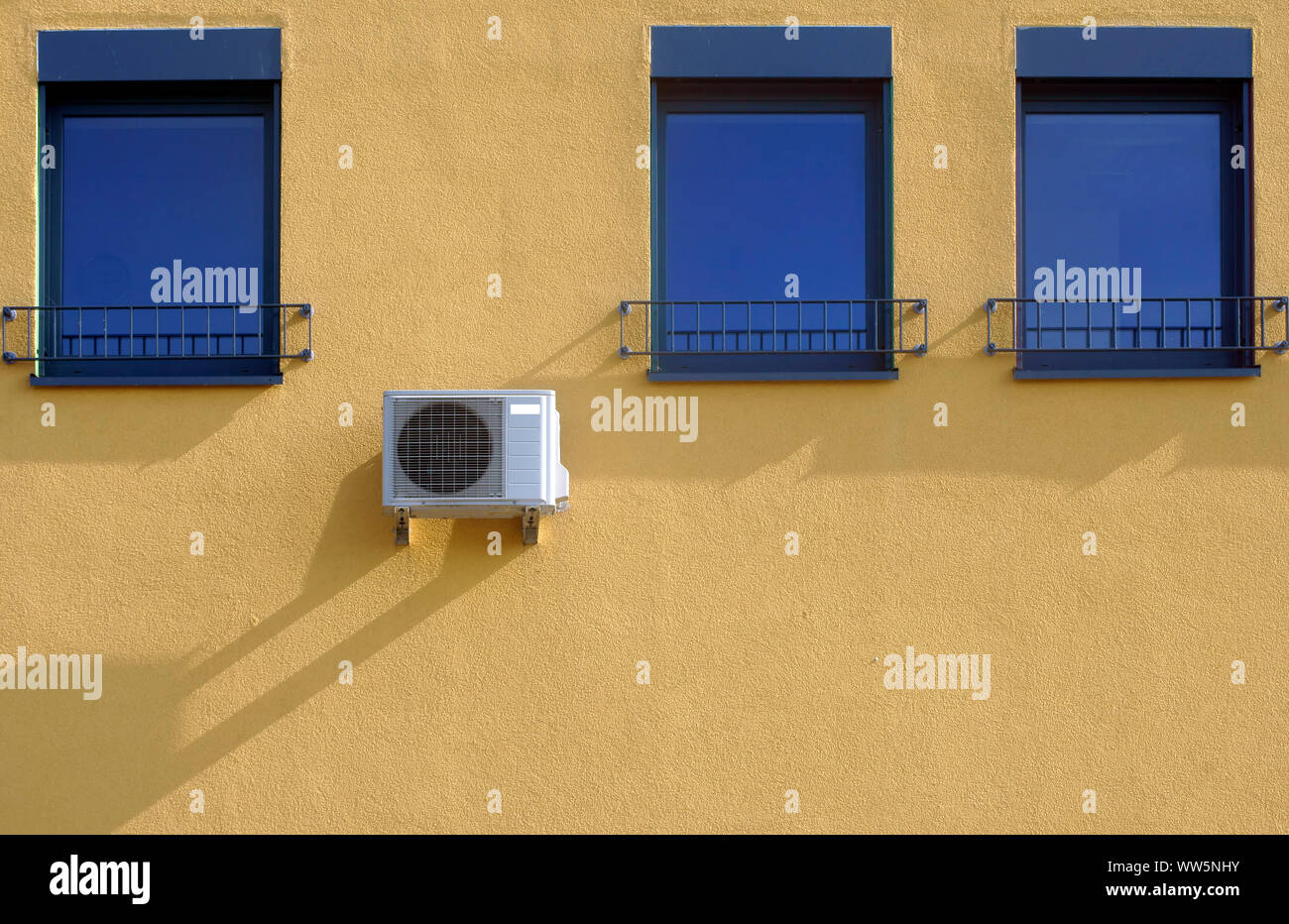 Blue windows air conditioning at light facade in sunlight hi-res stock ...