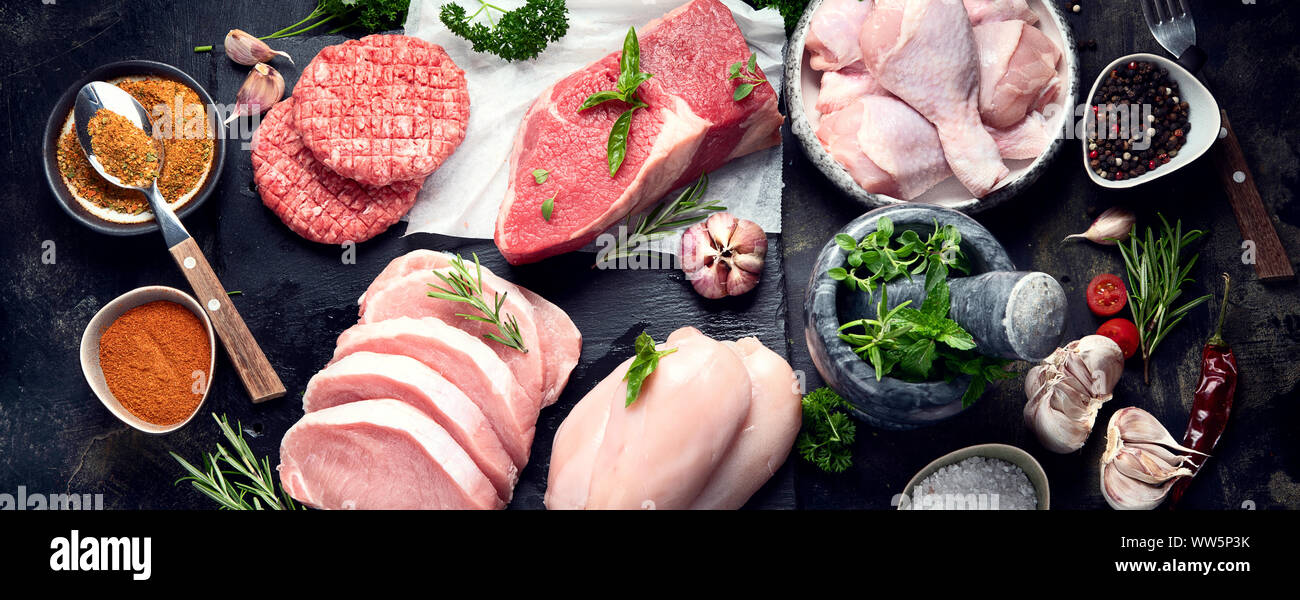 Different types of raw meat on black background. Top view. Panorama ...