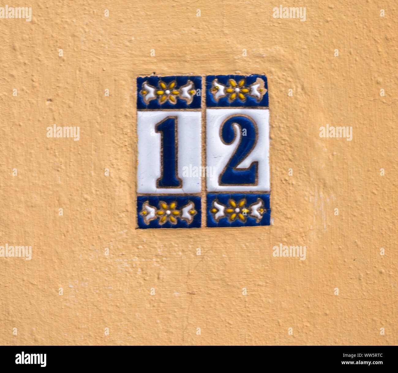 Decorative ceramic house number 12 tile on the wall, characteristic ...