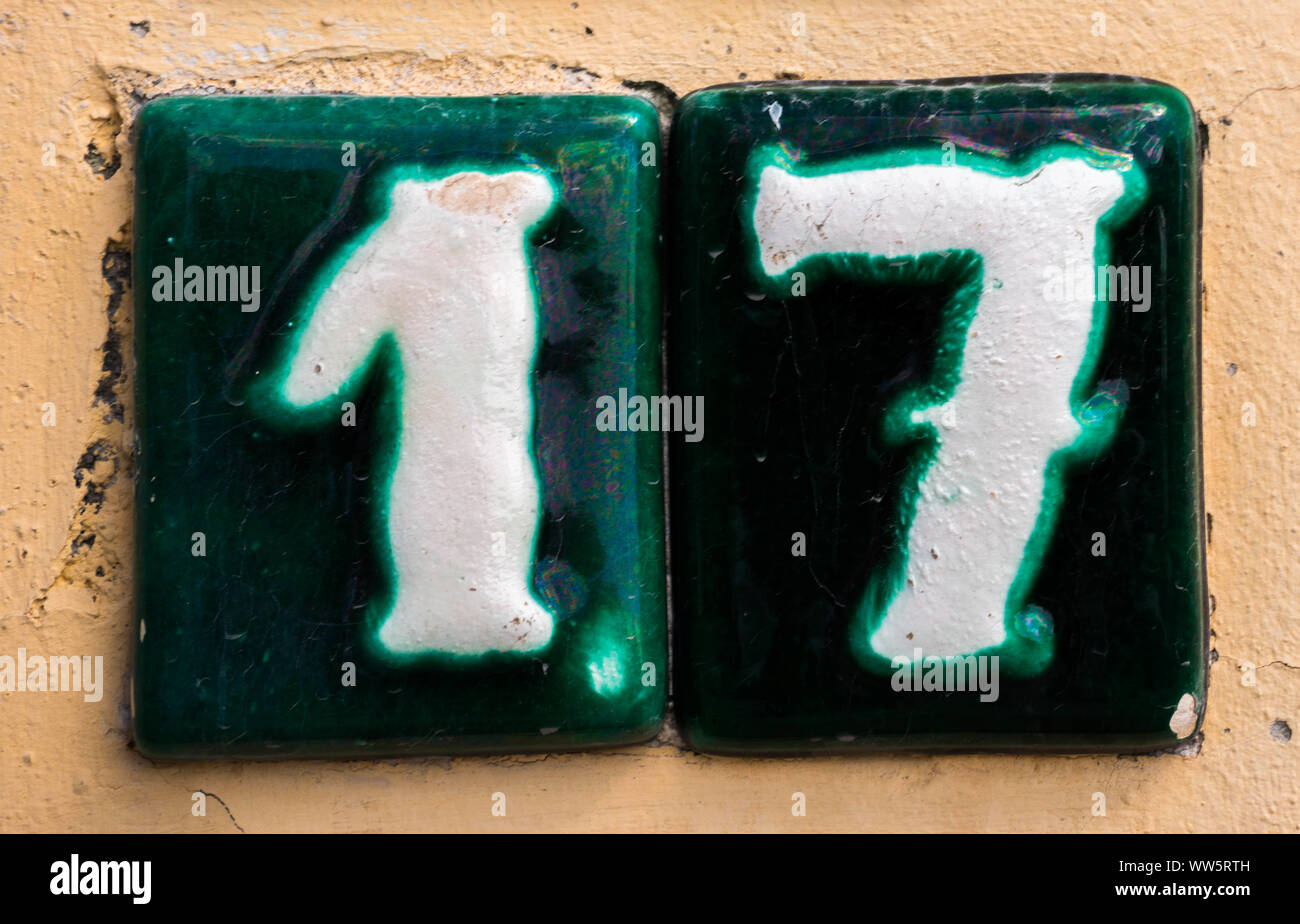 Decorative ceramic house number 17 tile on the wall, characteristic ...