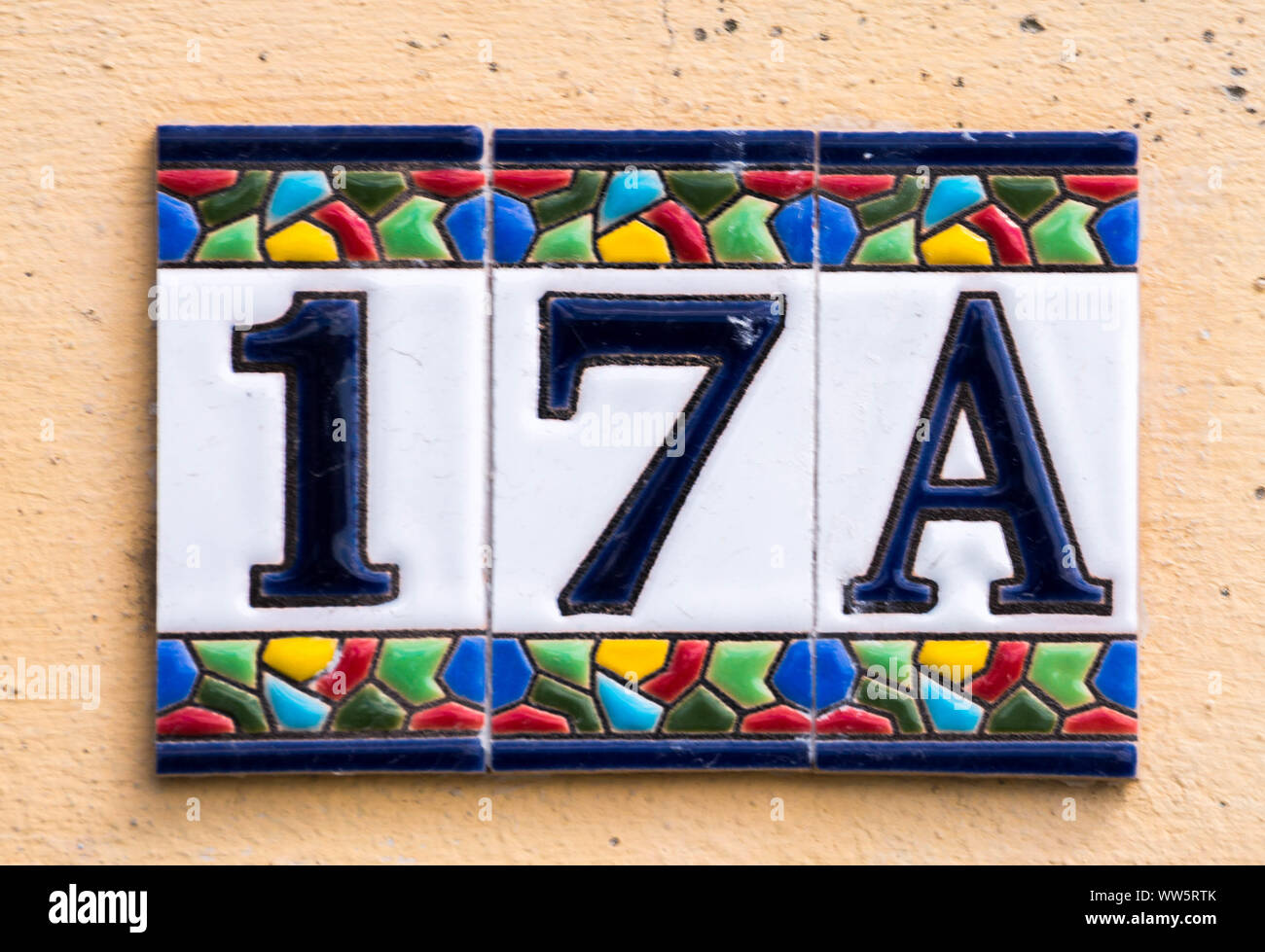 Decorative ceramic house number 17A tile on the wall, characteristic ...