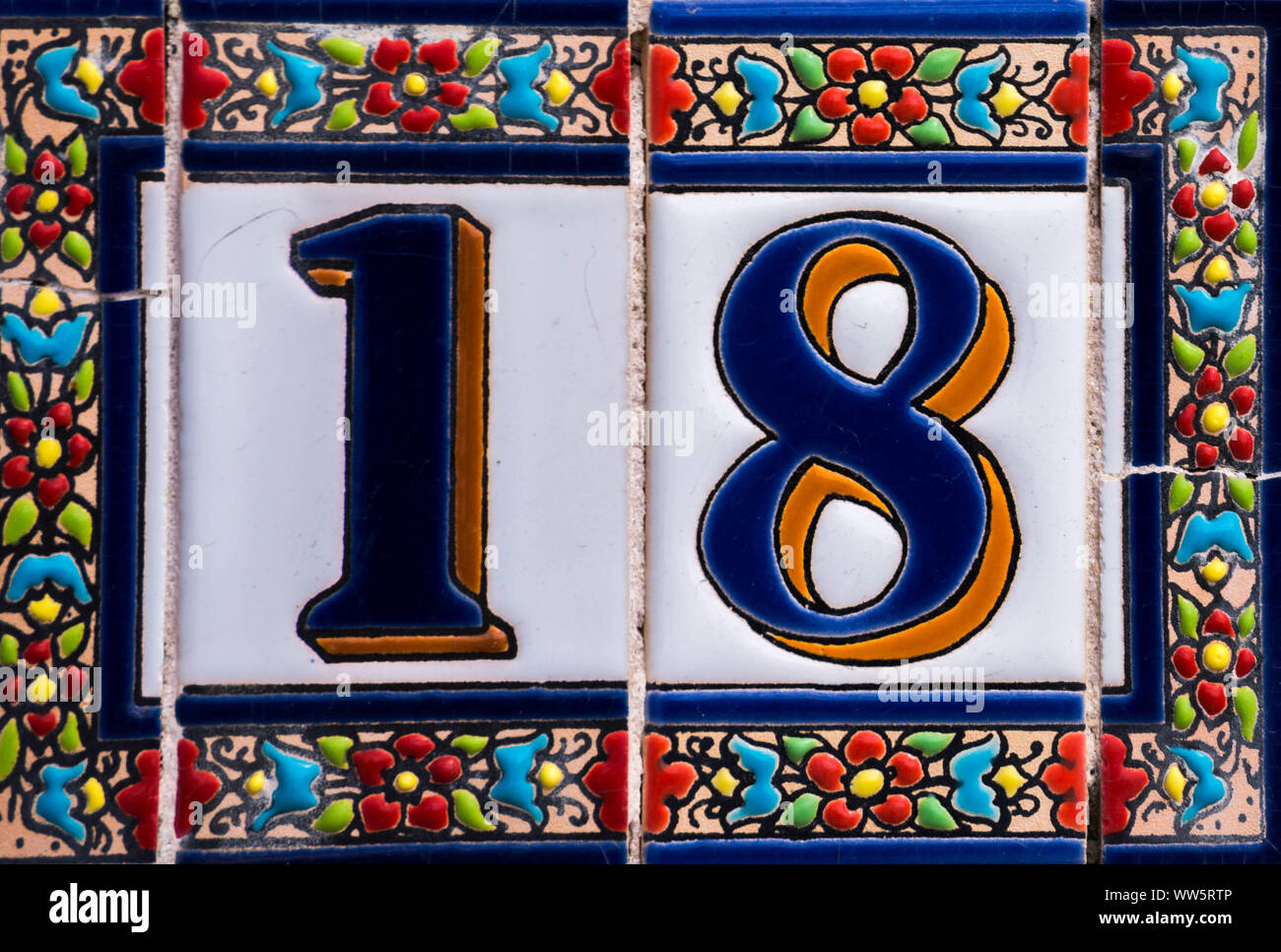 Decorative ceramic house number 18 tile on the wall, characteristic ...