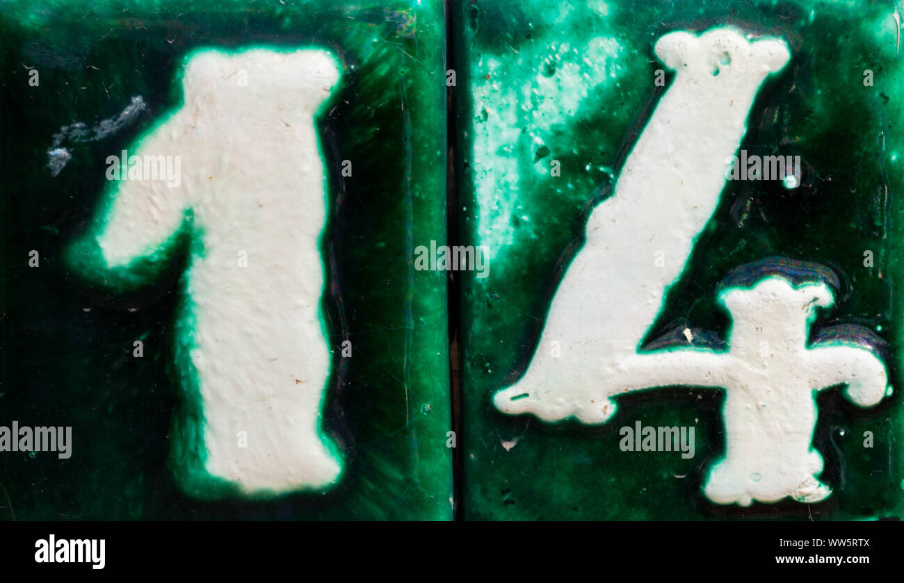 Decorative ceramic house number 14 tile on the wall, characteristic ...