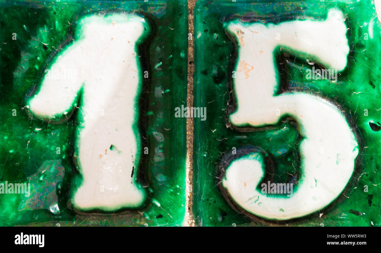 Decorative ceramic house number 15 tile on the wall, characteristic ...