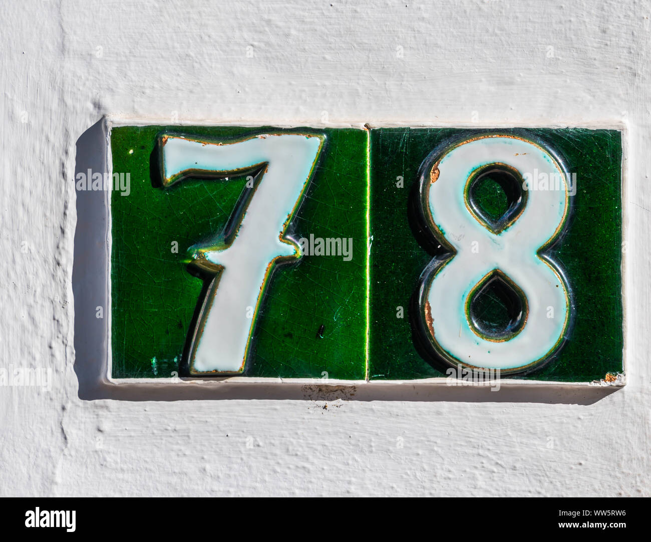 Decorative ceramic house number 78 tile on the wall, characteristic ...