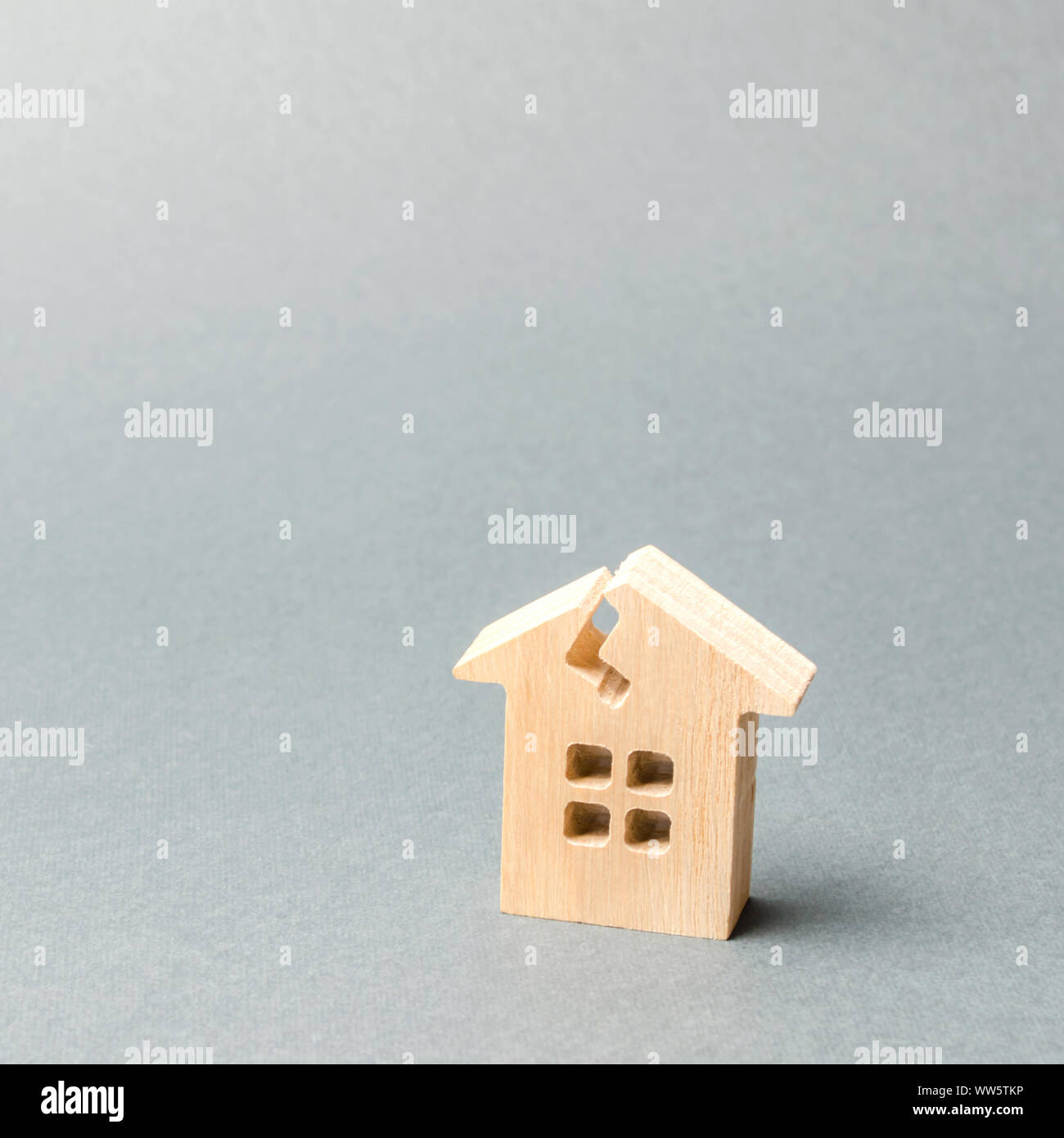 A wooden house with a crack. The concept of a damaged house ...