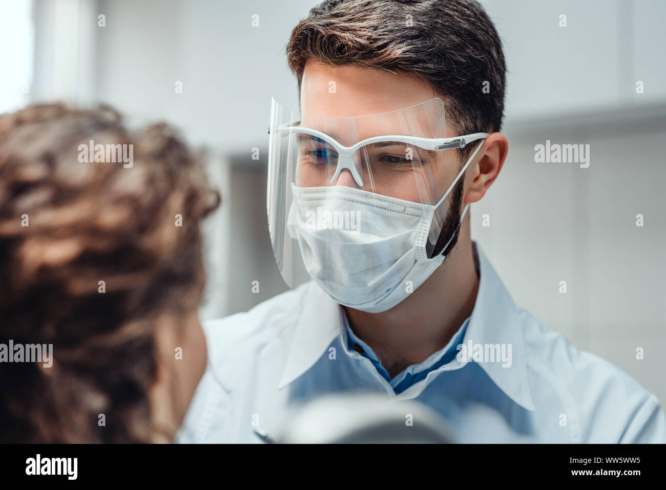 Man dentist at work with patient. At the dentist office, examination ...