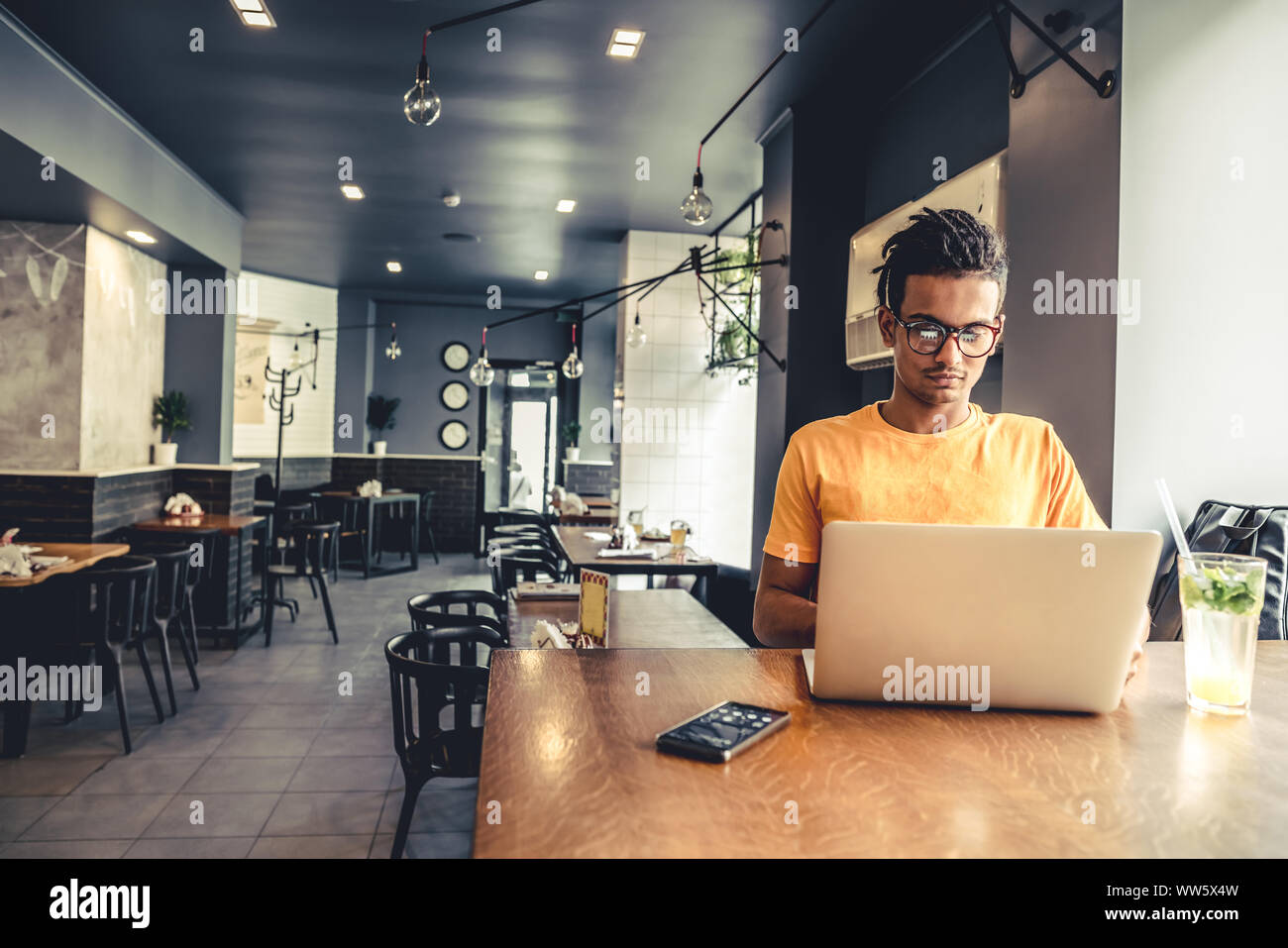 Handsome and successful indian man freelancer work laptop in cafe ...