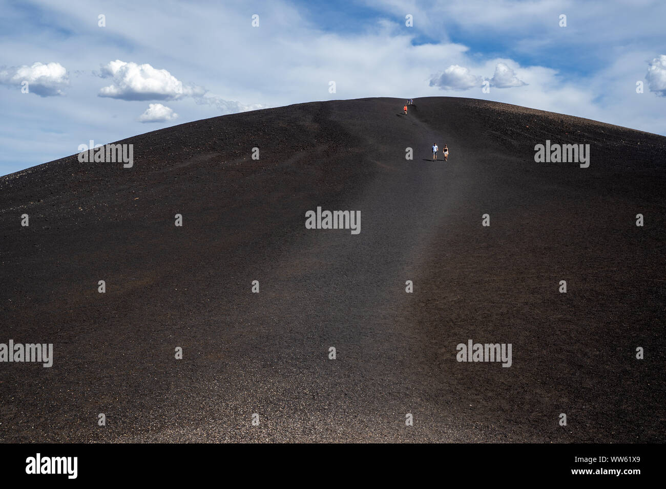 Hikers walk down from the Inferno Cone at Craters of the Moon National ...