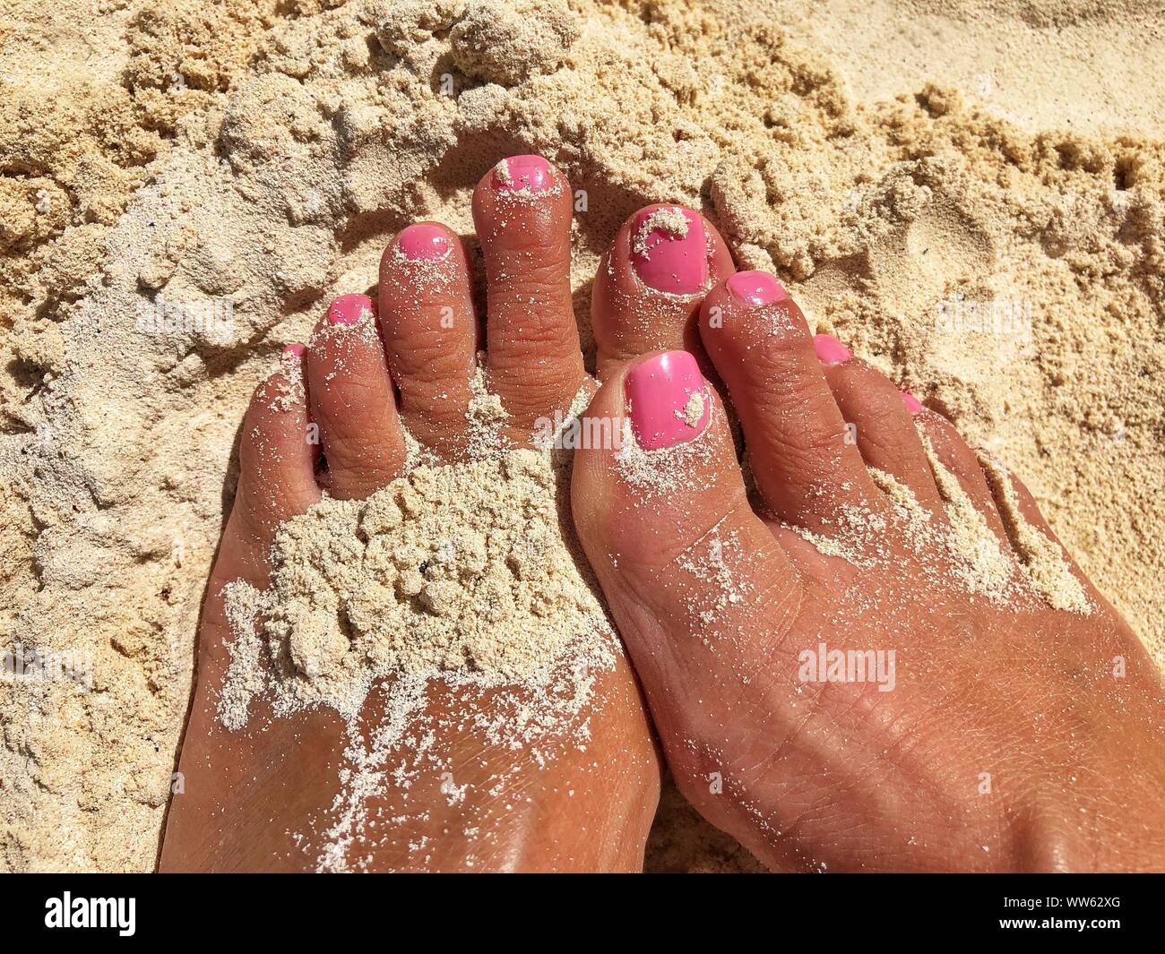 Pink toes covered in sand on the beach, Yucatan Peninsula, Tulum ...