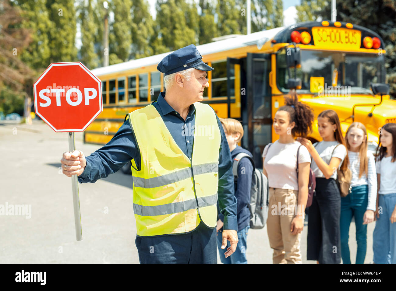 Group of children going out the school bus ready to cross the road ...