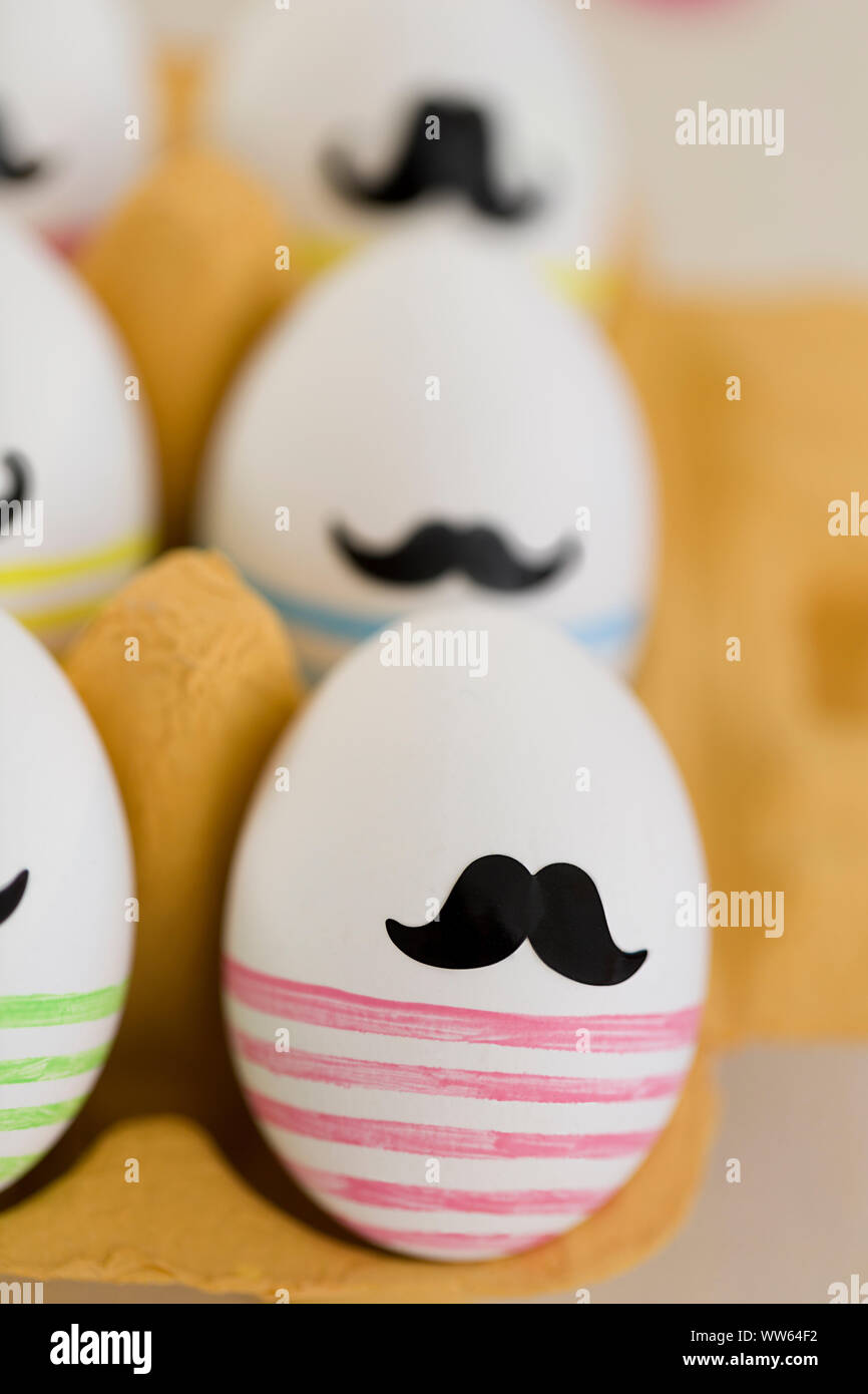 Easter eggs with moustache and stripes in the egg carton Stock Photo ...