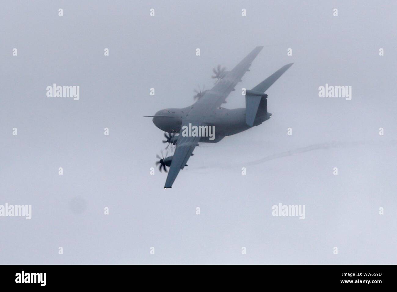An Airbus A400M gives a low level flying display, almost disappearing ...