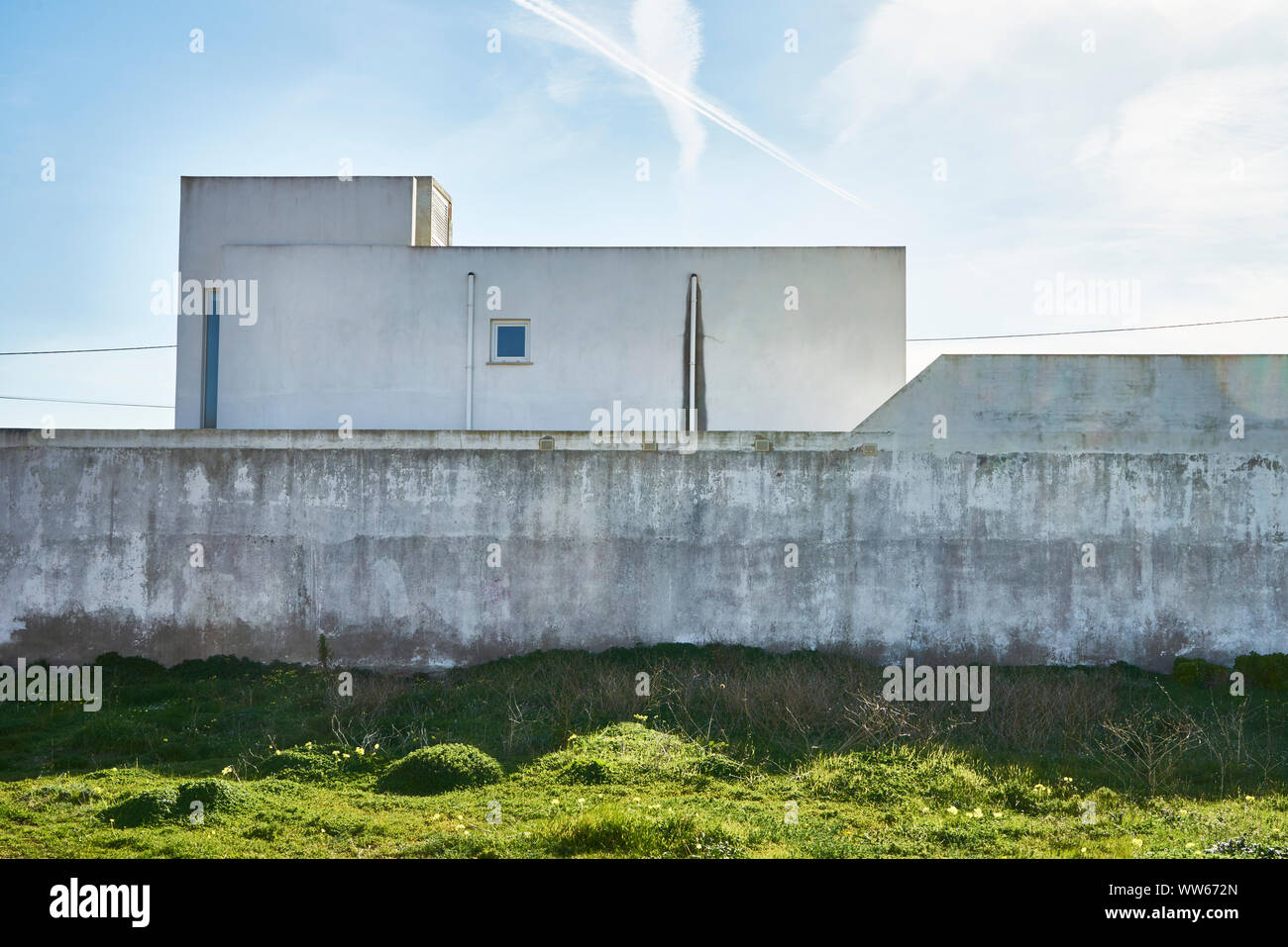 House with garden and wall to the neighbour Stock Photo - Alamy