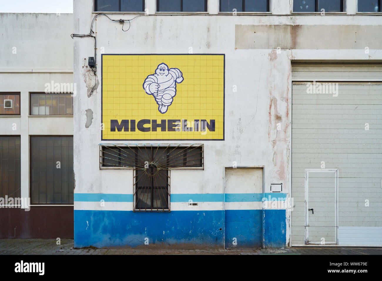 Billboard from tiles on the facade of a warehouse with gate Stock Photo ...