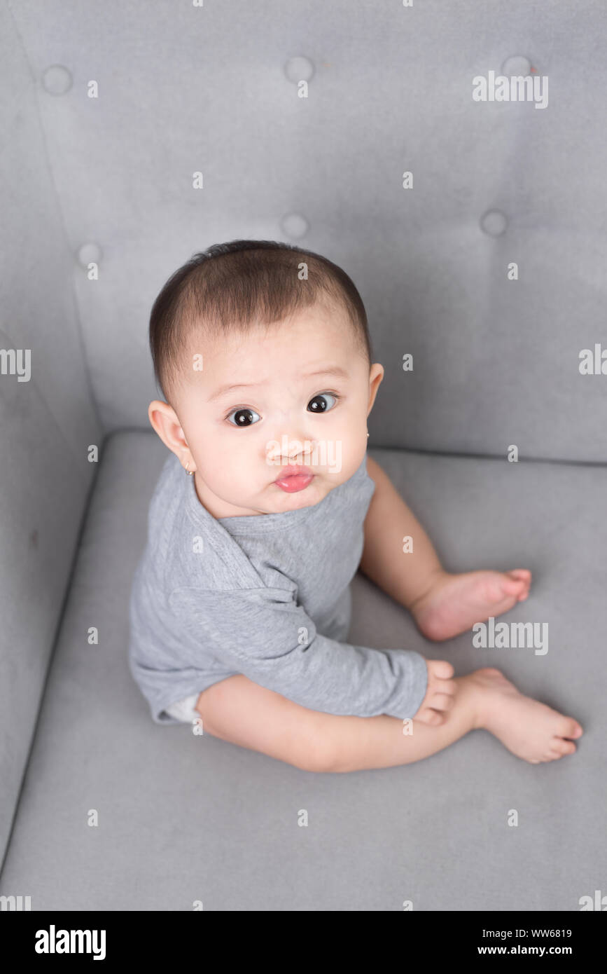 childhood, babyhood and people concept - happy little baby girl sitting ...