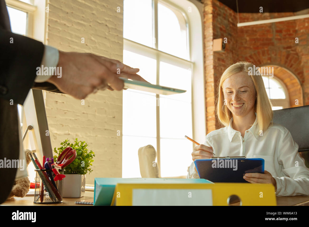 A young businesswoman moving in the office, getting new work place ...