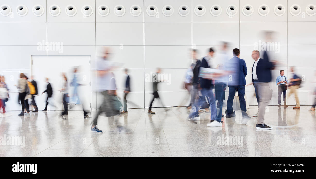 Anonymous blurred crowd at trade fair or conference Stock Photo - Alamy