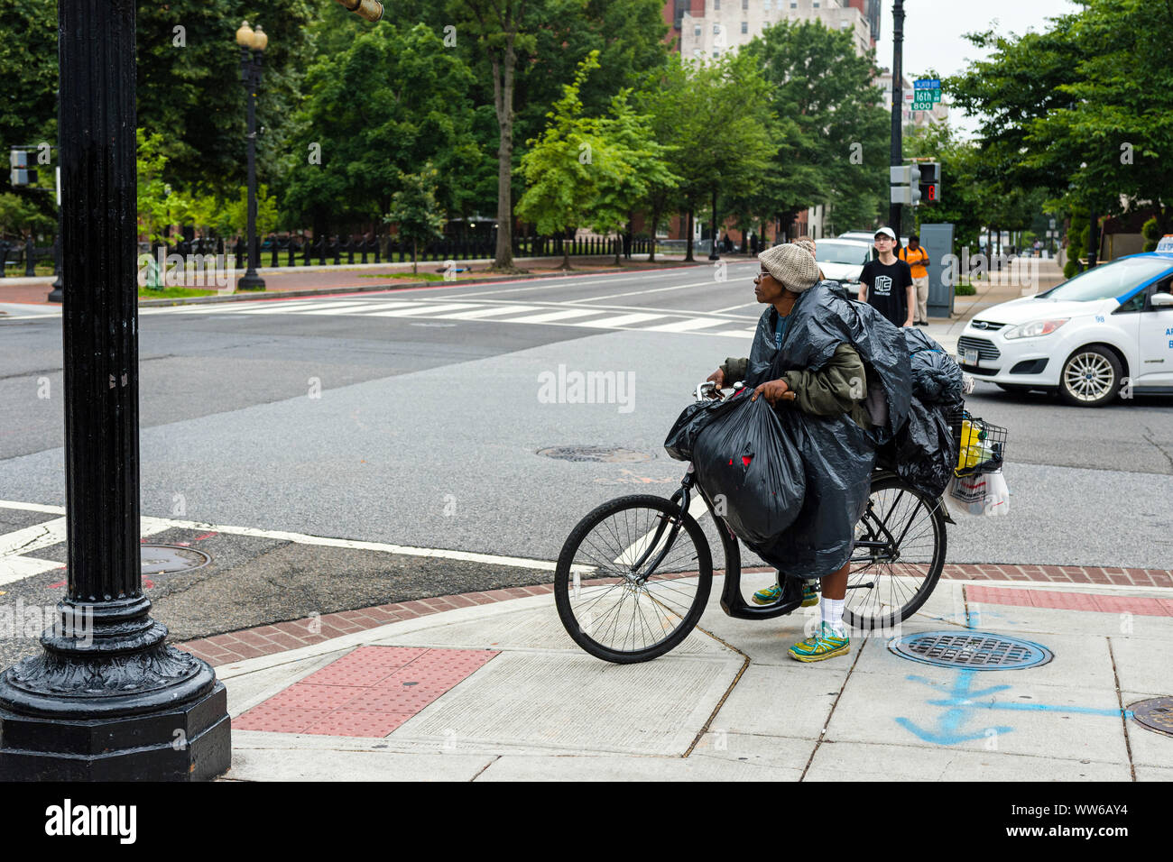 Washington DC, USA - June 9, 2019: A homeless man in a bike is waiting ...