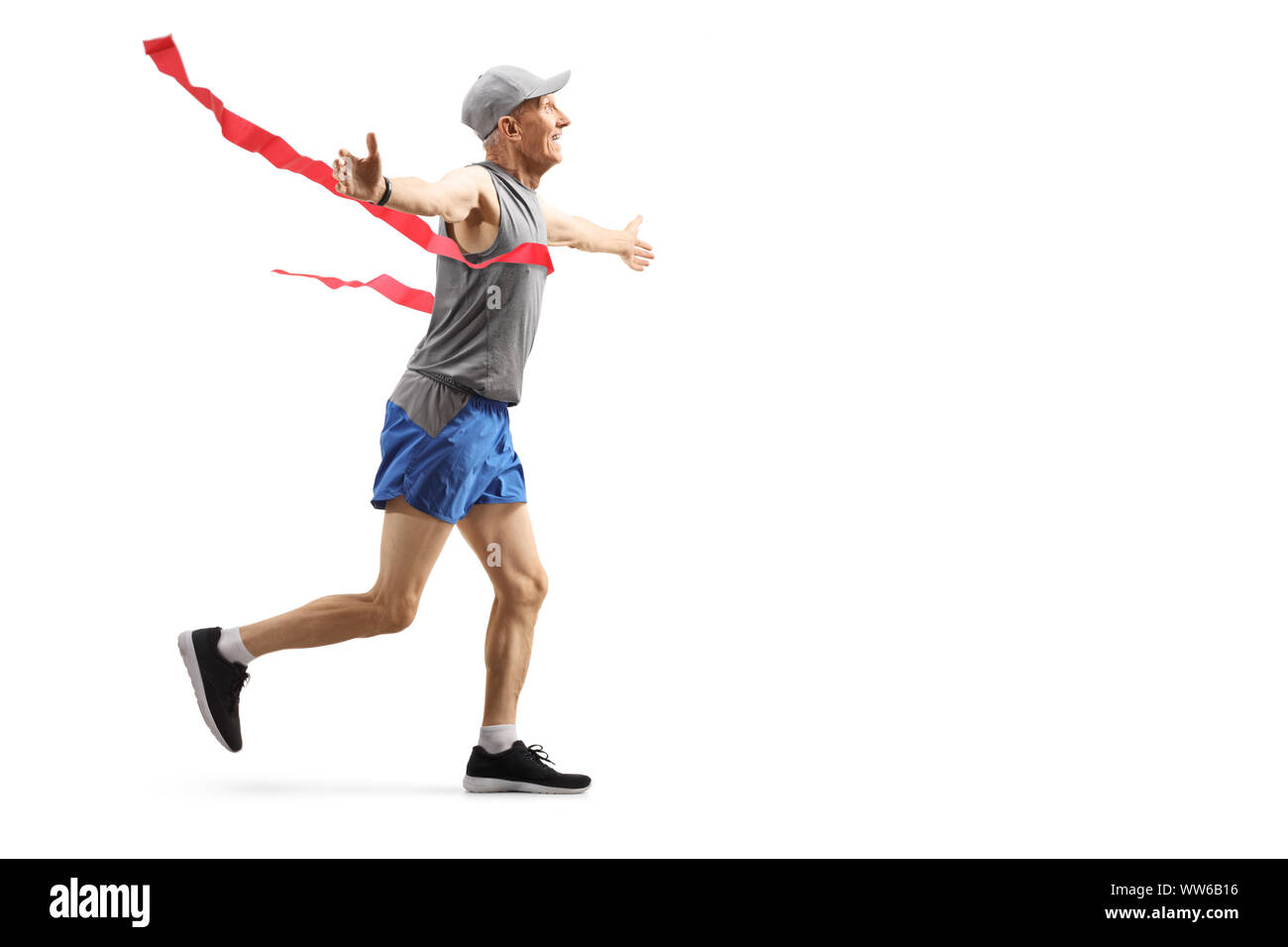Full length profile shot of a senior male runner on the finish line ...