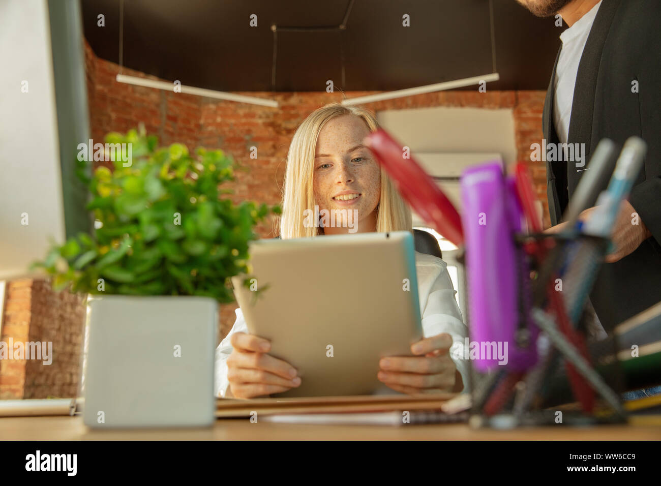 A young businesswoman moving in the office, getting new work place ...