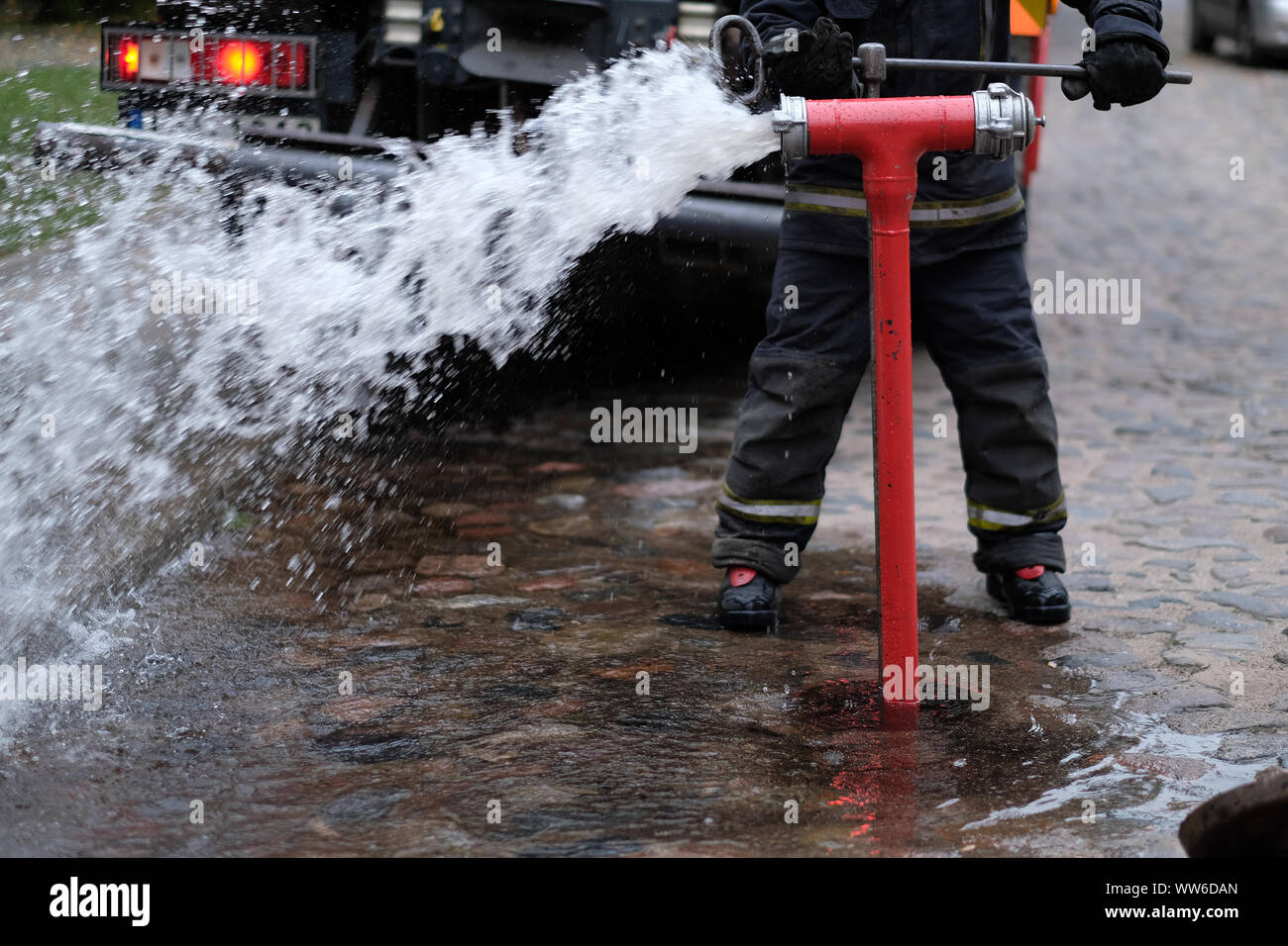 The fireman opens a fire hydrant to extinguish a fire Stock Photo - Alamy
