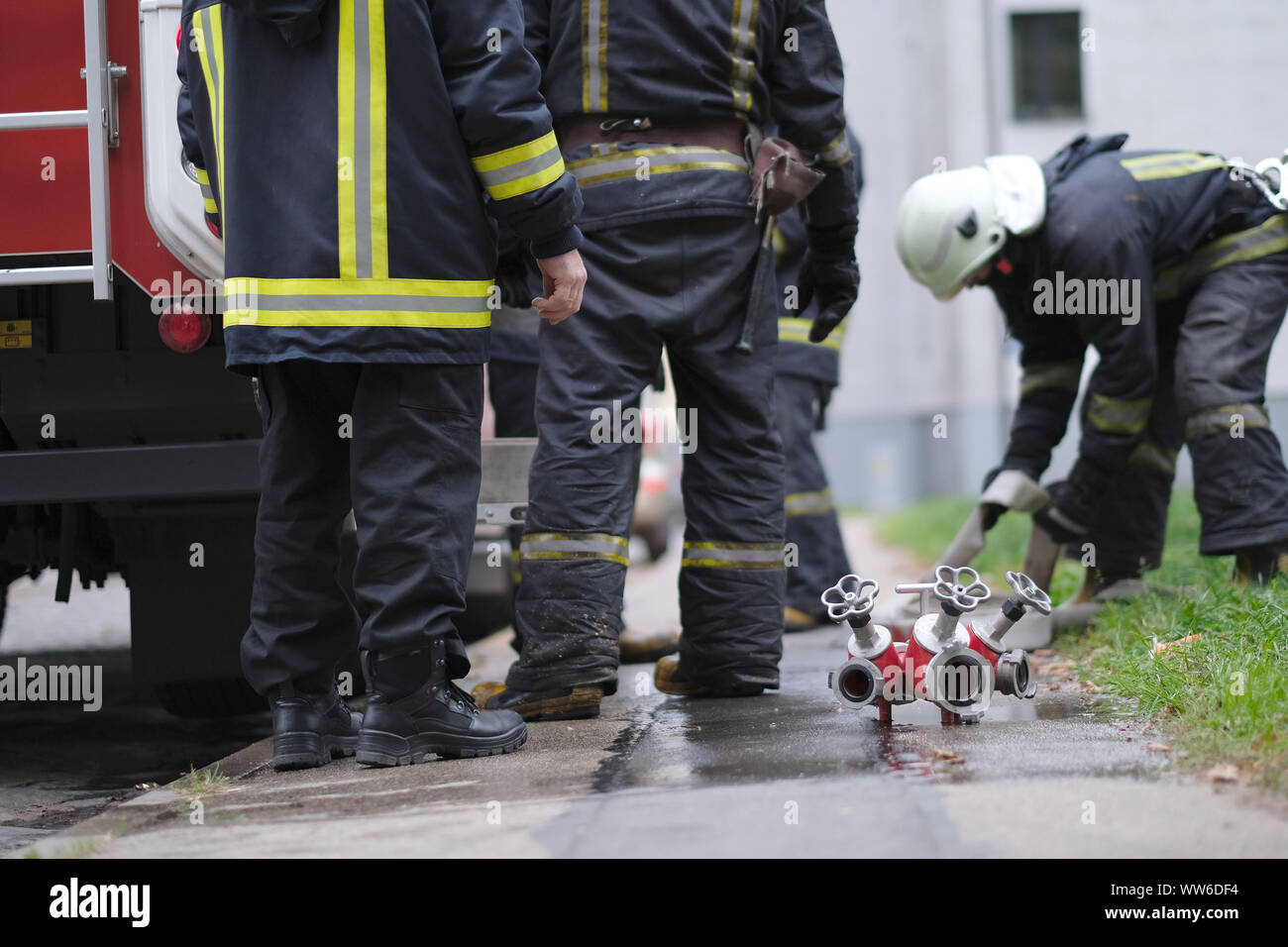 Members of the fire brigade store the equipment after the work done in ...